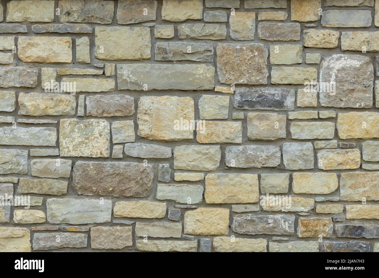 Solid yellow and beige stone wall. Stone background Stock Photo - Alamy