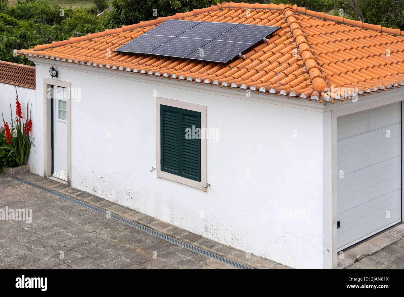 Three photovoltaic solar panels on the roof of a garage Stock Photo - Alamy