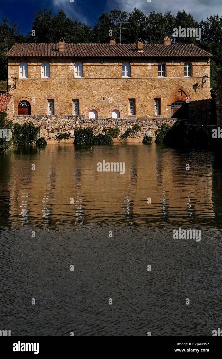 Honey-coloured stone buildings surround the 16th century Bath of St ...