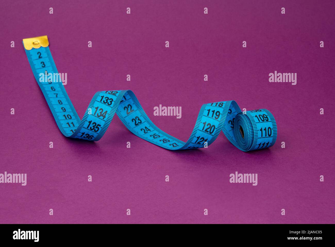 Colorful tape measure spiral with copyspace background Stock Photo - Alamy