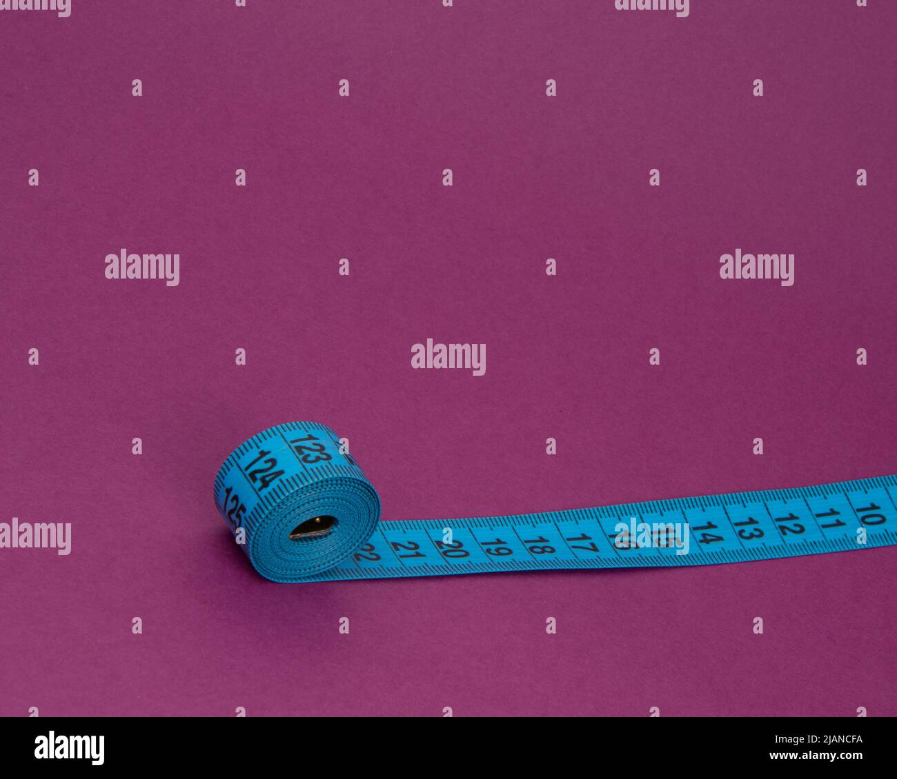 Colorful tape measure spiral with copyspace background Stock Photo - Alamy