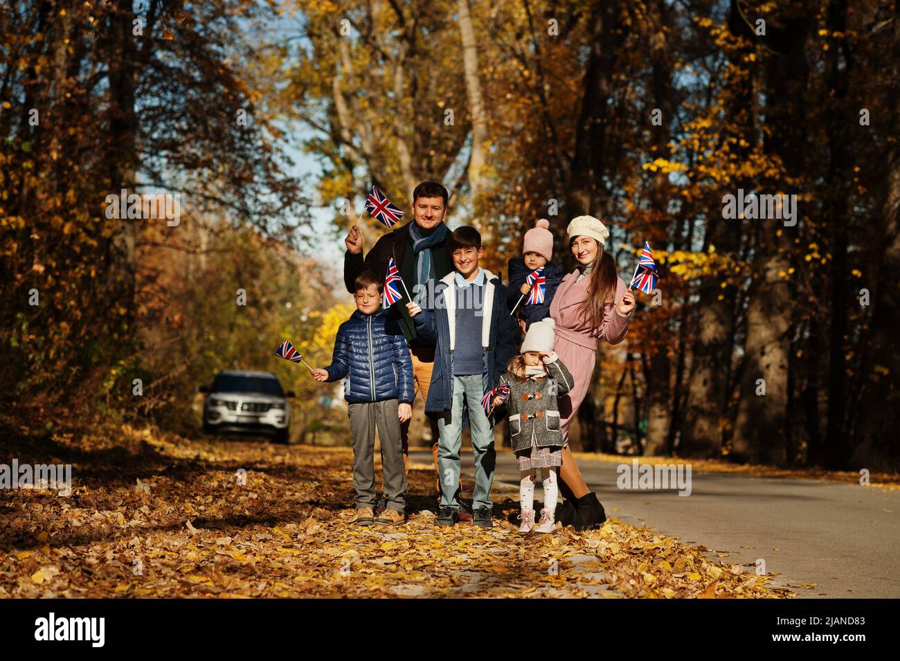 National holiday of United Kingdom. Large family with four kids holding ...