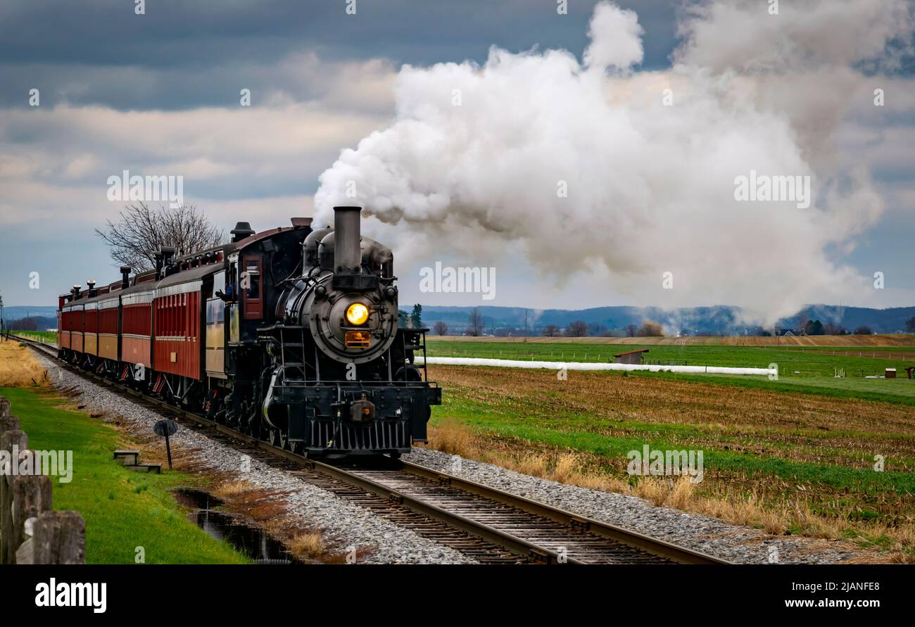 A Antique Restored Steam Engine and Coaches Approach Thru Corn Fields ...