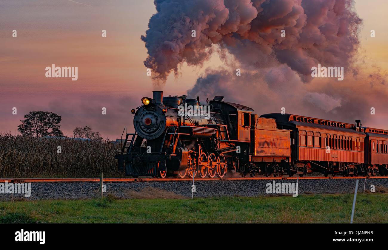 A View of an Antique Steam Passenger Train Approaching at Sunrise With ...