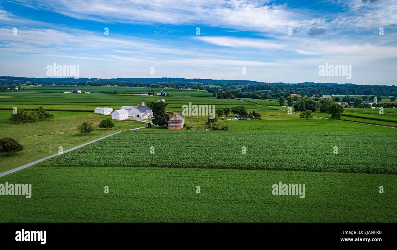 Aerial View of Farmlands With Barns and Silos, Looking Over the Hills ...