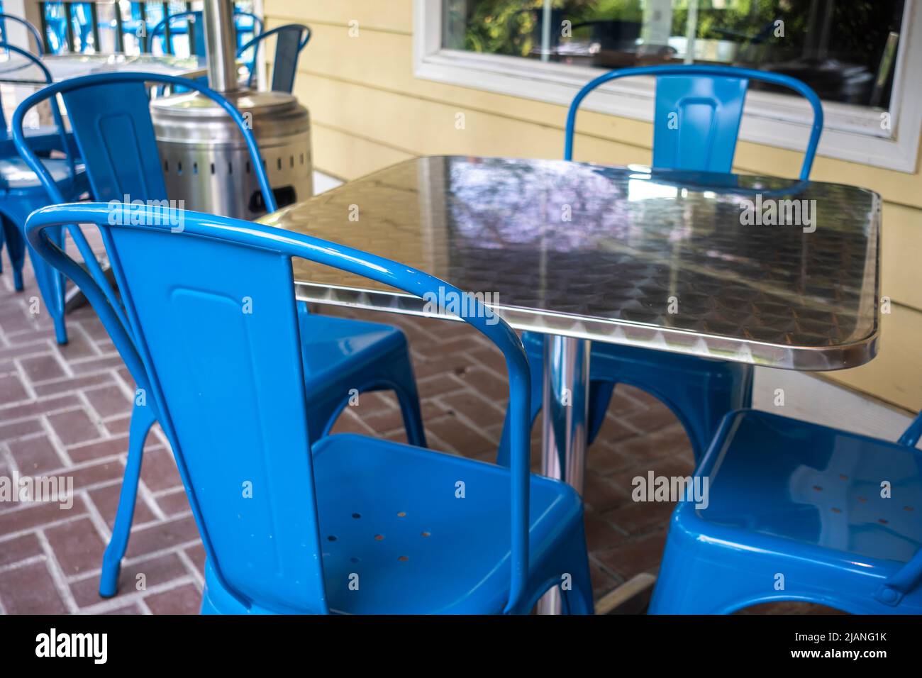 Colorful view of bright blue chairs gathered around a reflective metal ...