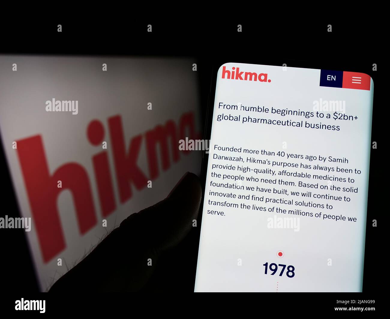 Person holding cellphone with logo of British company Hikma ...