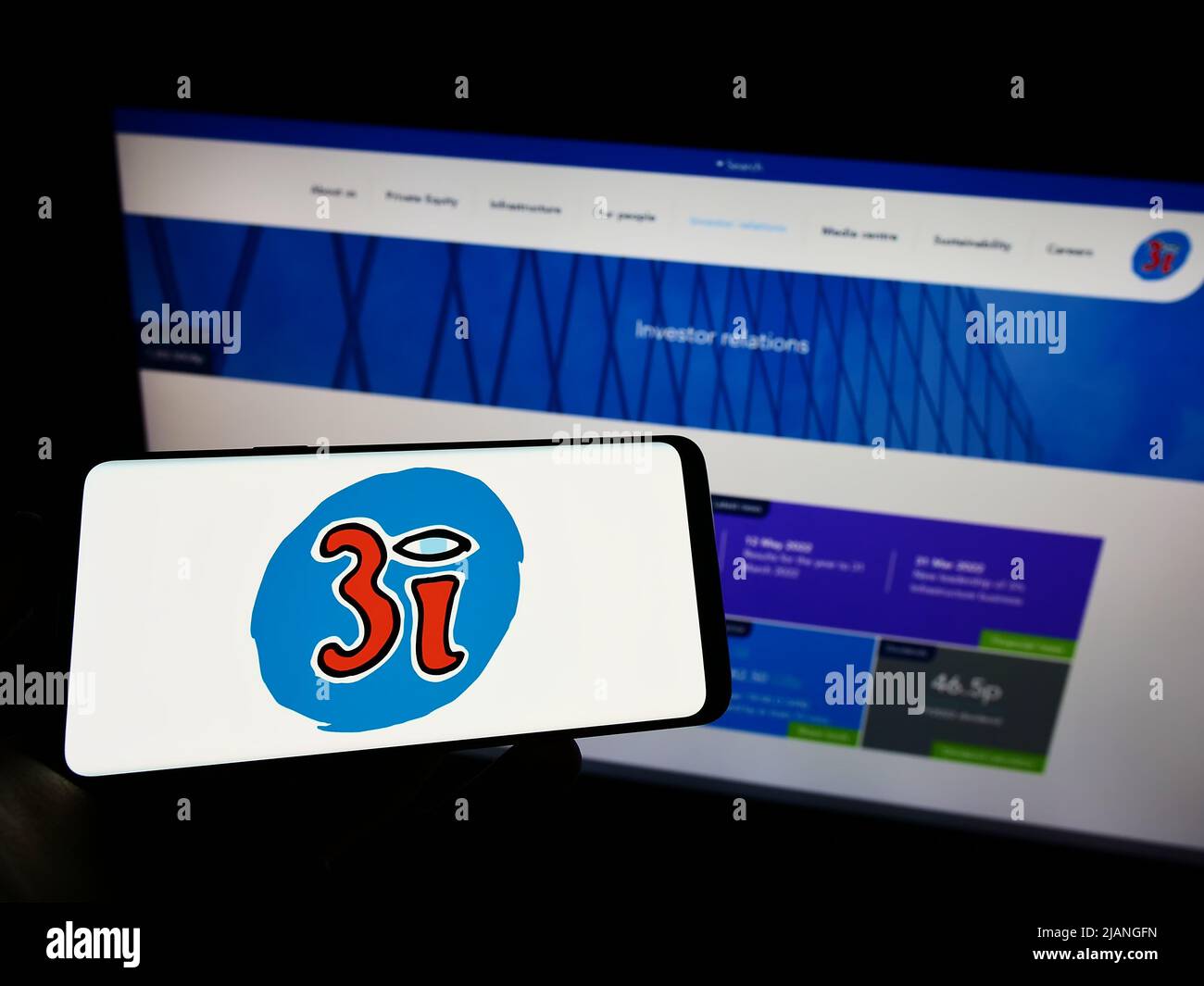 Person holding cellphone with logo of British investment company 3i Group plc on screen in front ...