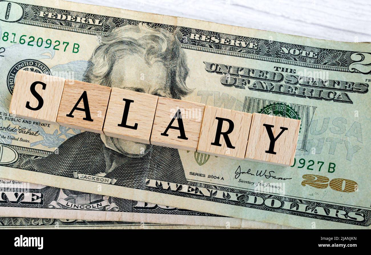 Salary word written on wood block with American Dollar-bills. Directly ...