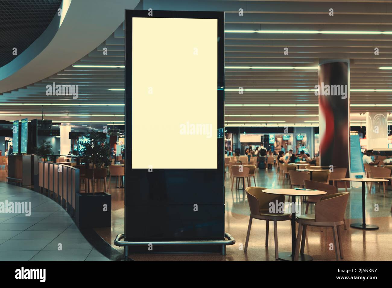 A blank vertical advertising billboard in front of a crowded mall food ...
