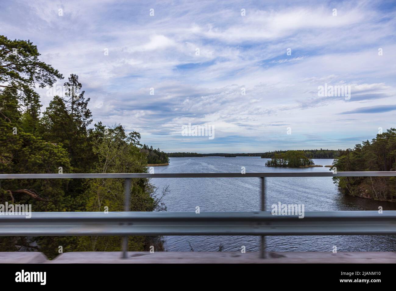 Blurred view from vehicle passing bridge over wonderful lake. Sweden ...