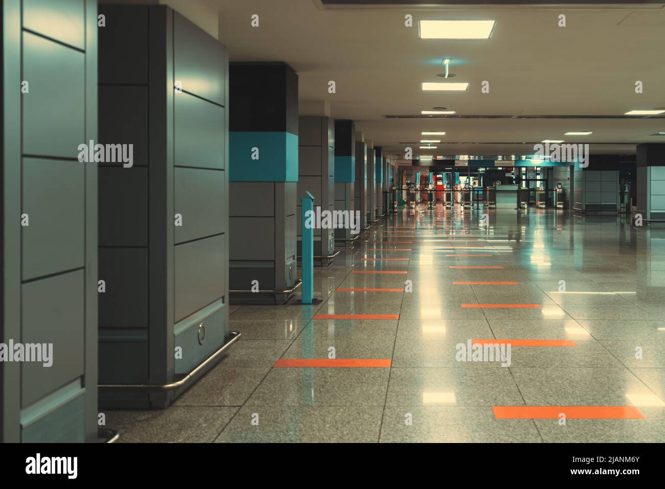 A long empty corridor in the passenger control area indoors of a modern ...
