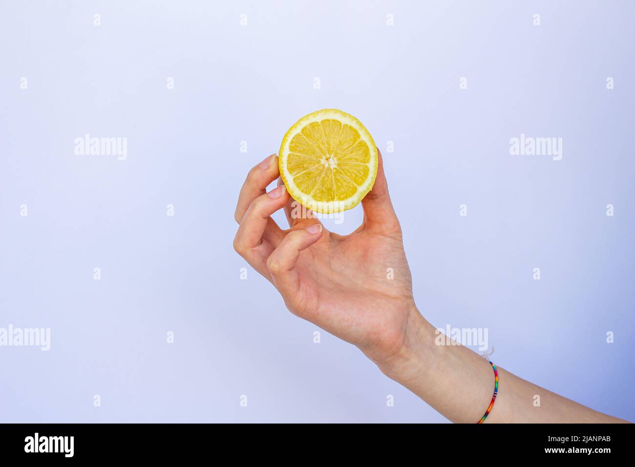 Closeup hand holding half lemon, isolated on white background Stock ...