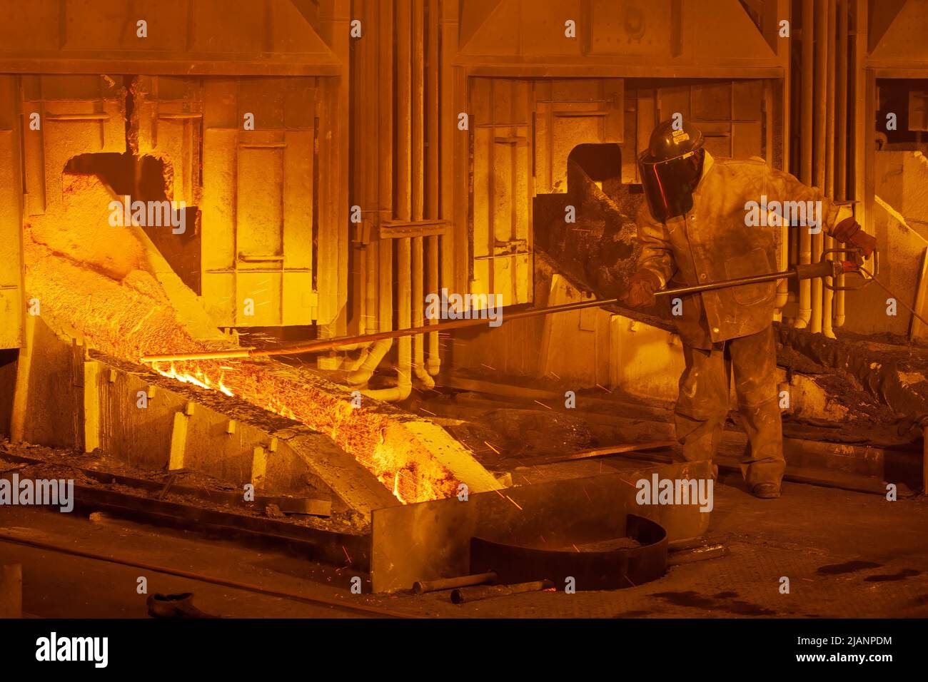 Man maintaining flow of molten copper, First Quantum Minerals copper ...