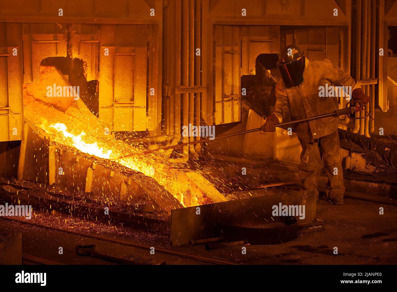 Man maintaining flow of molten copper, First Quantum Minerals copper ...