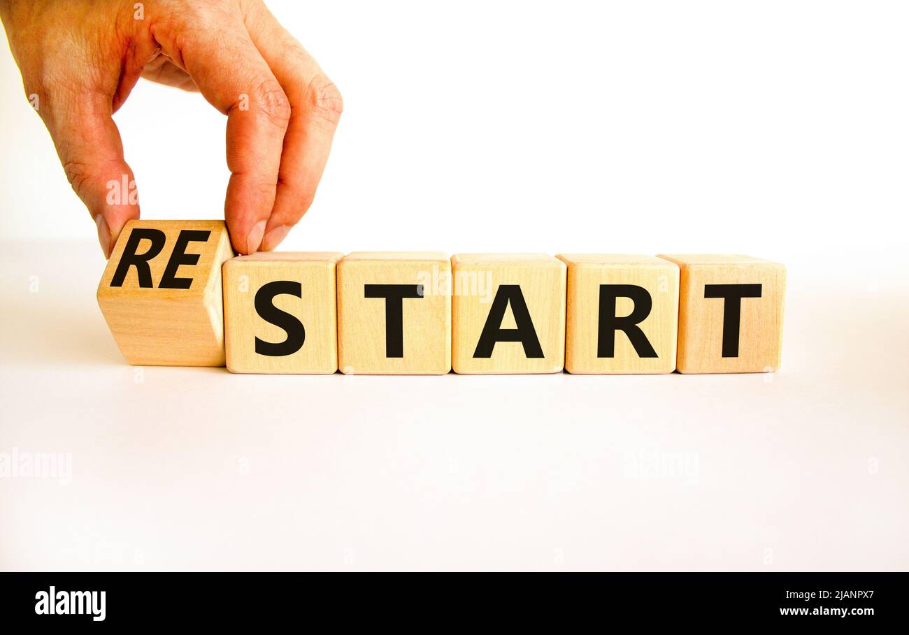 Start or restart symbol. Businessman turns wooden cubes and changes the ...