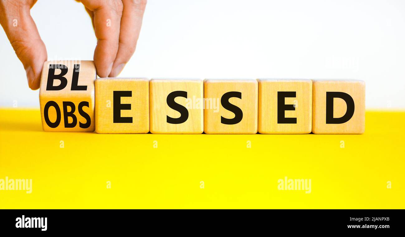 Blessed or obsessed symbol. Businessman turns wooden cubes and changes ...