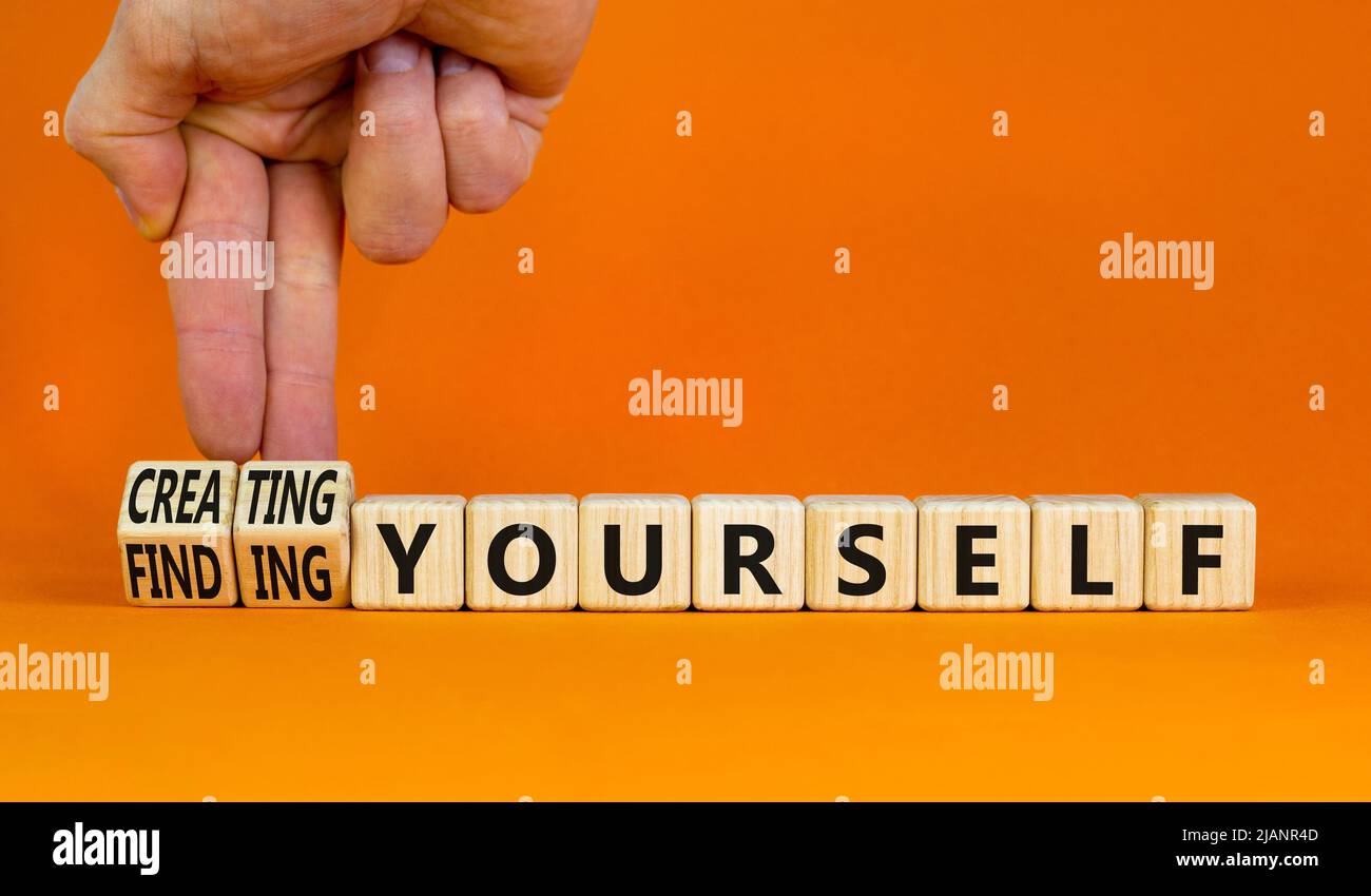 Finding or creating yourself symbol. Businessman turns wooden cubes and ...