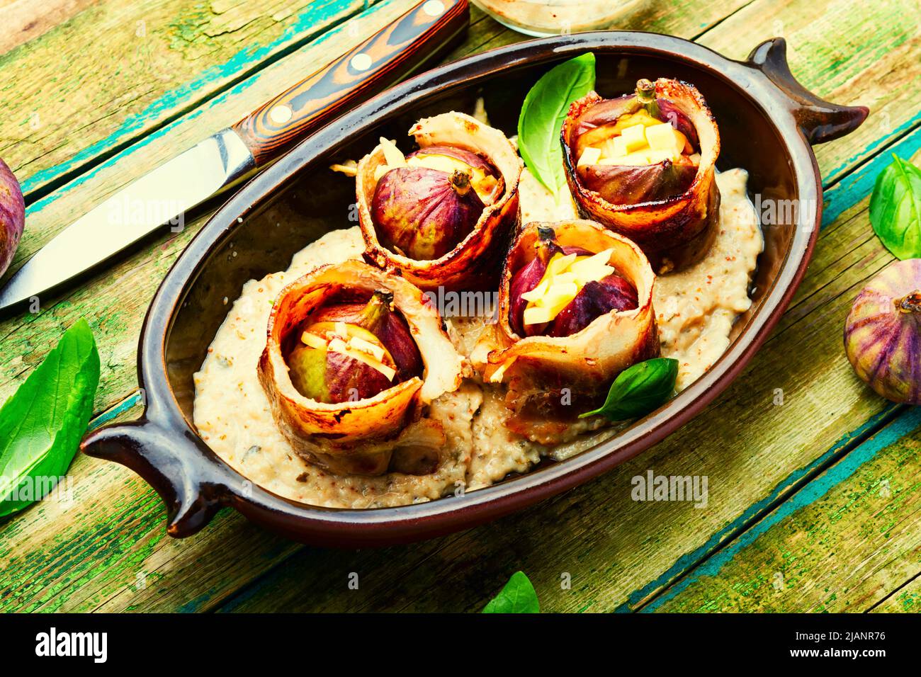 Figs fried with cheese baked with bacon and Greek yogurt sauce Stock ...