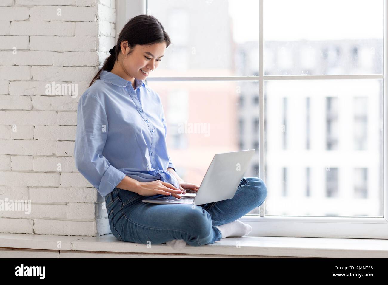 Positive asian freelancer using hi-res stock photography and images - Alamy