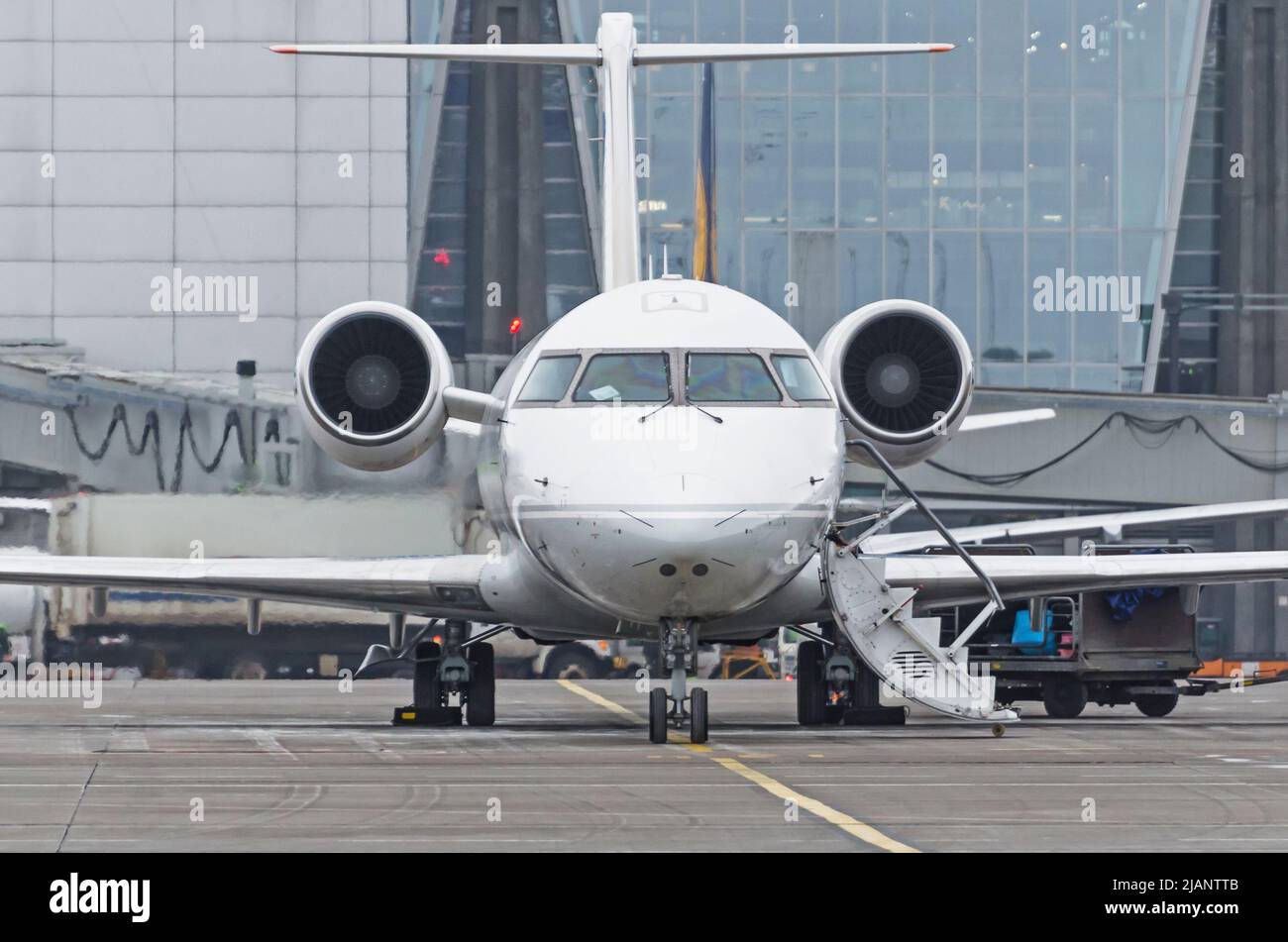 A small passenger plane parked in front of the airport terminal ...