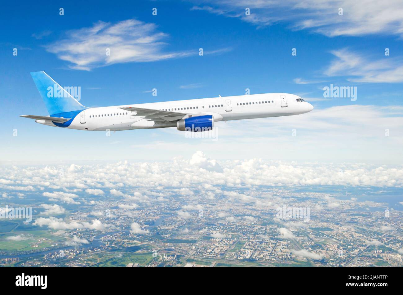 Travel over the city commercial flight airplane Stock Photo - Alamy