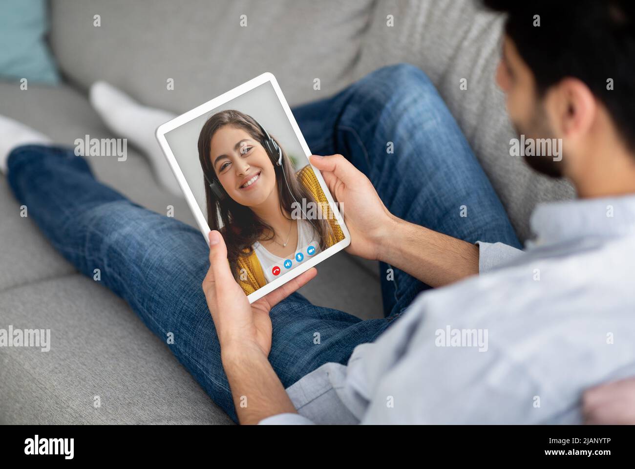 Millennial arab man using digital tablet, calling girlfriend Stock ...