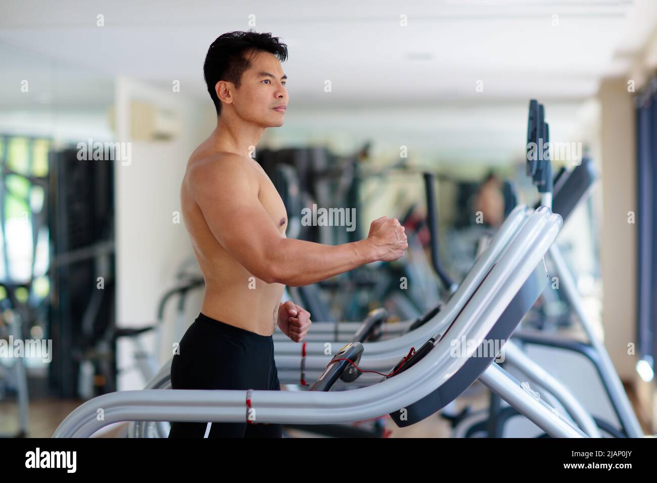 Man exercising in gym. Asian bodybuilder lifting weights. Sport and ...