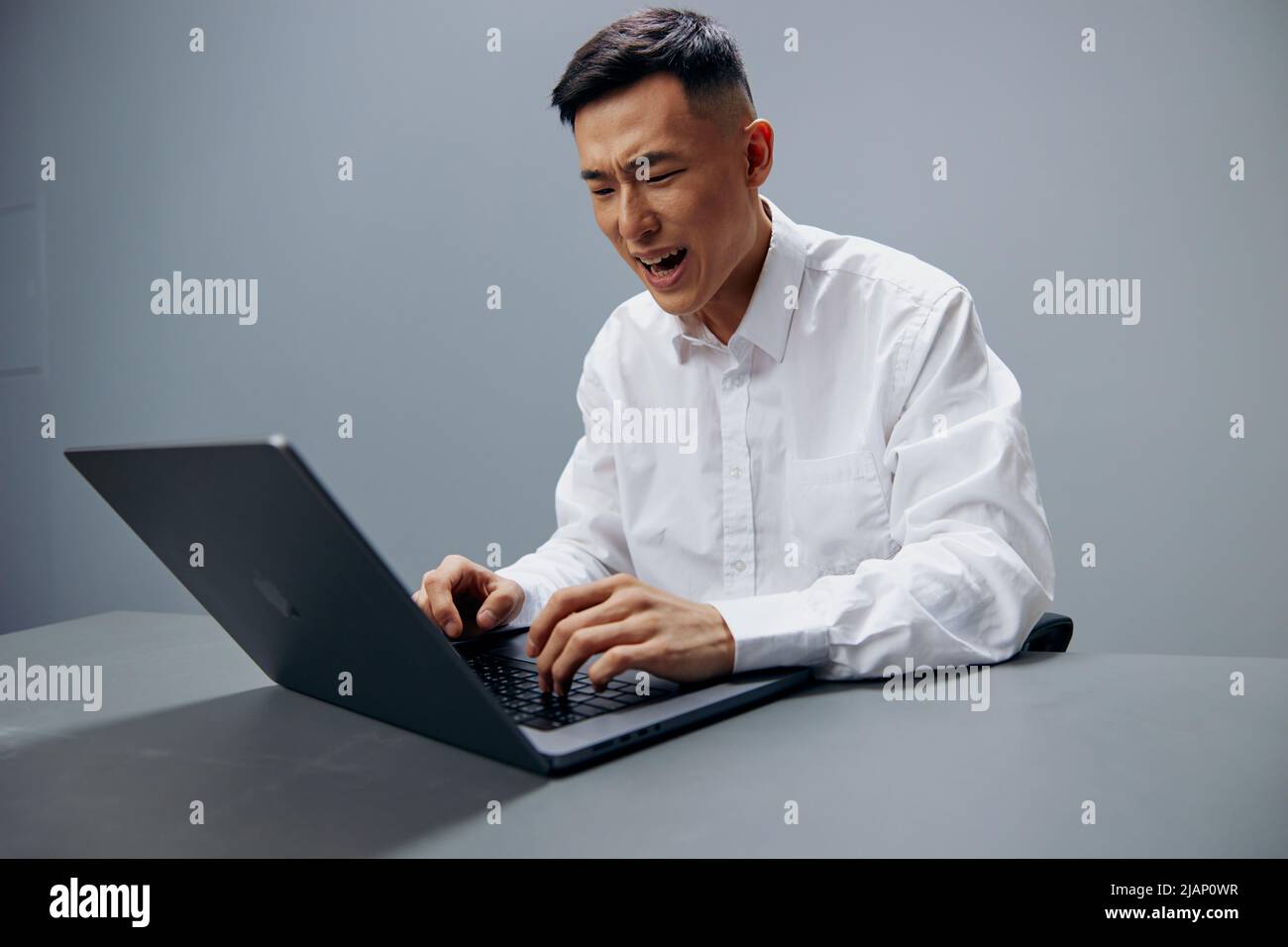 worker working on a laptop sitting at a table in the office Lifestyle ... worker working on a laptop sitting at a table in the office Lifestyle ...