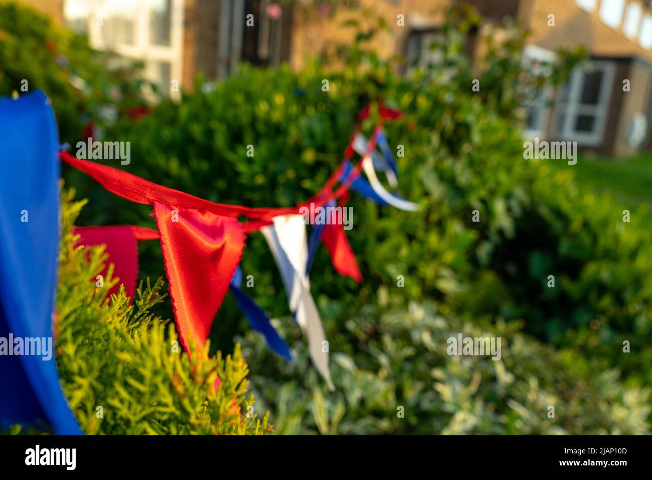 Bunting flags in colors of british flag, white, red and blue each in ...
