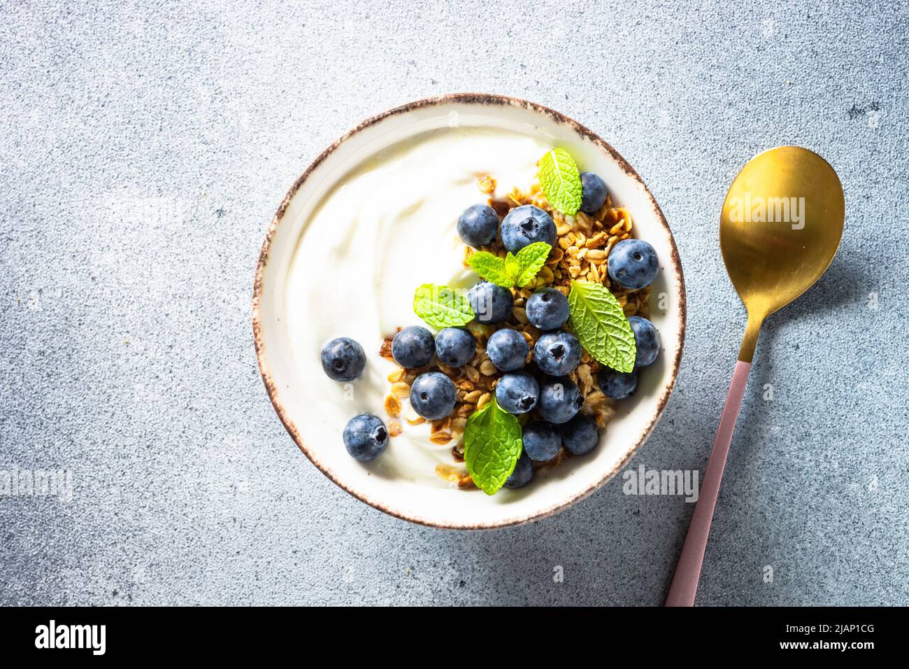 Greek Yogurt, granola and blueberry at light stone table Stock Photo ...