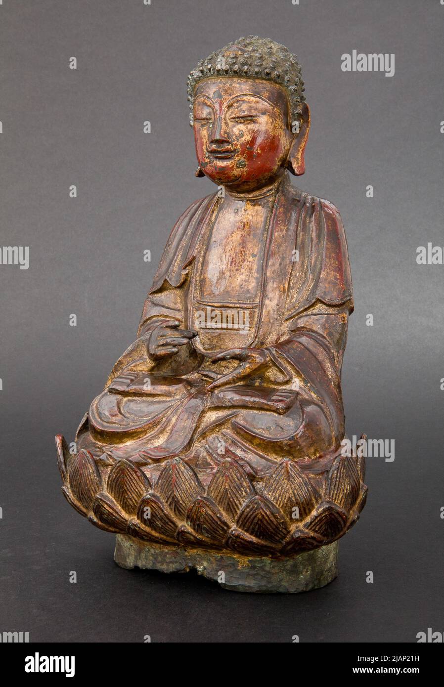 Figurine a Buddha sitting on a lotus throne unknown Stock Photo - Alamy