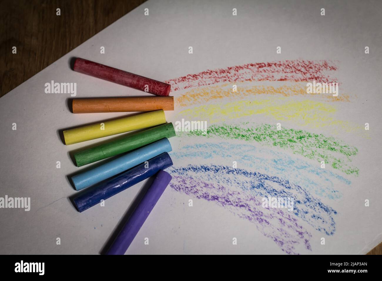 crayons to draw and color lines on a white sheet of paper Stock Photo ...