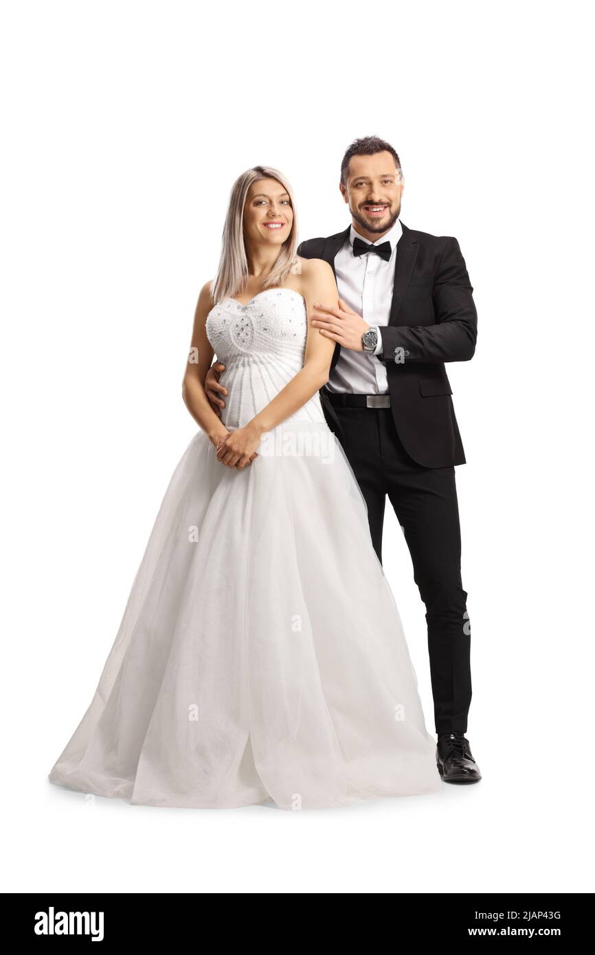 Full length portrait of a bride and groom posing isolated on white ...