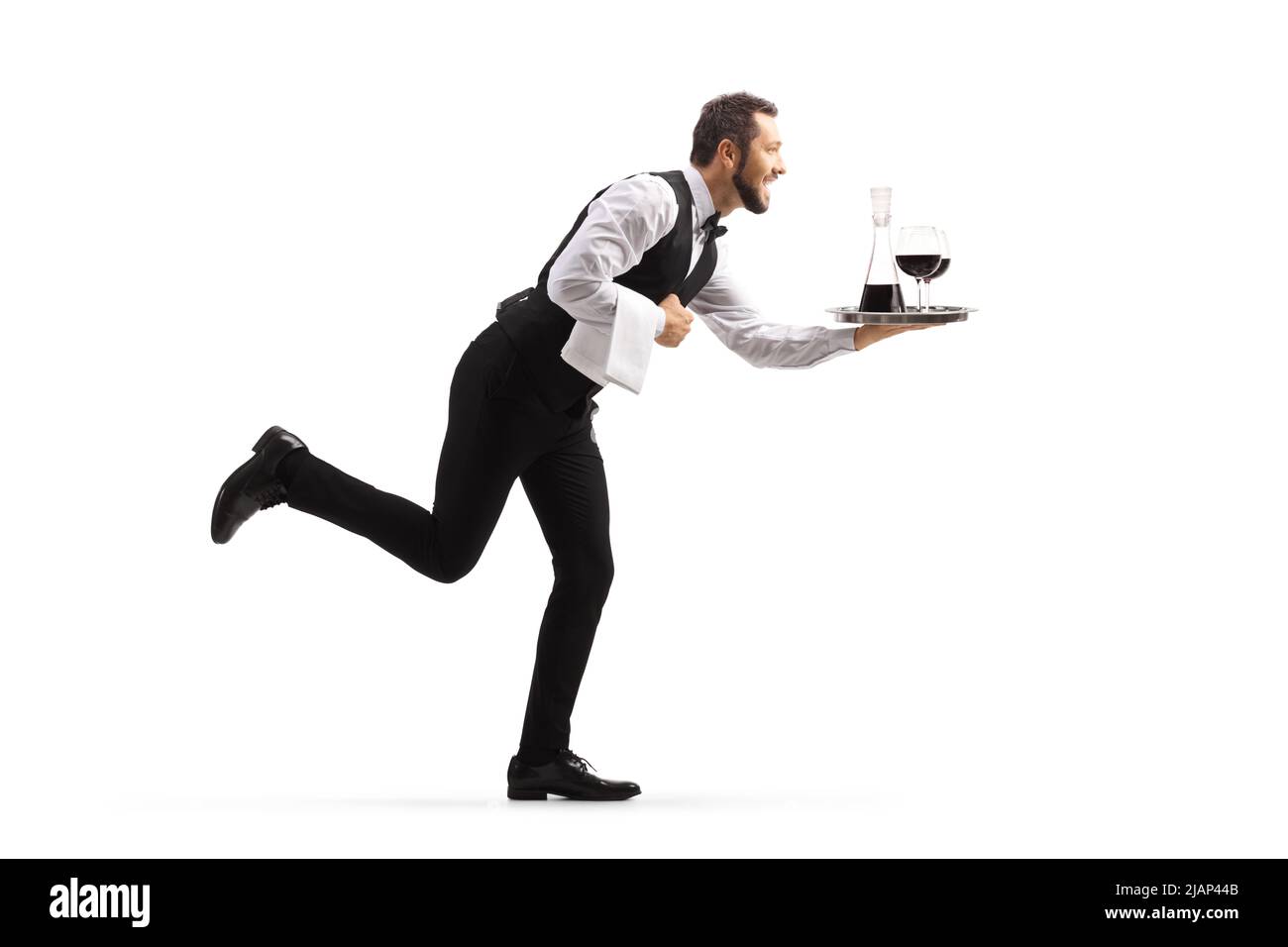 Full length profile shot of a waiter running with wine on a tray isolated on white background ...