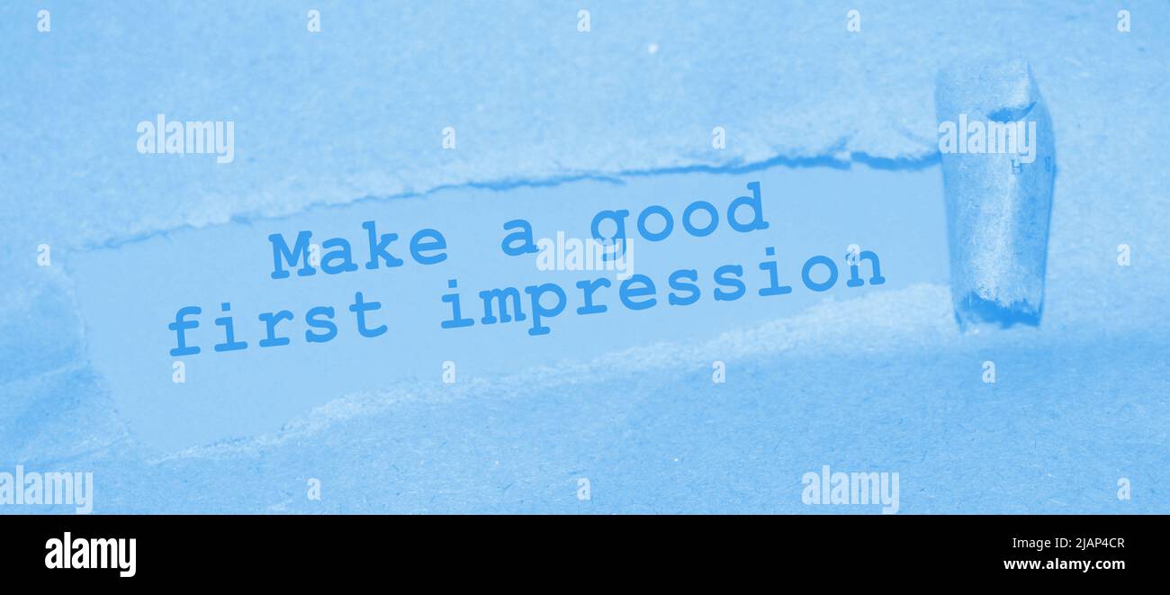 The text Make a good first impression appearing behind torn brown paper ...