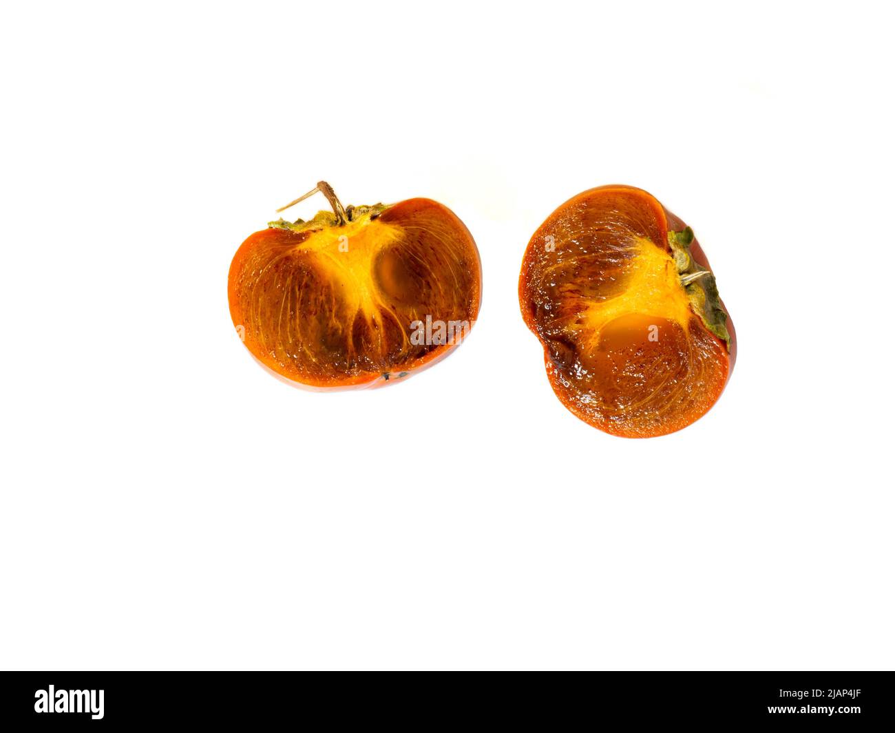 Cut in half ripe persimmon on a white background. Chocolate persimmon ...