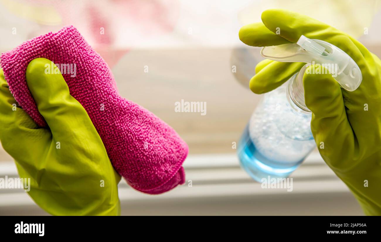 Close up in woman hands rag and window cleaner Stock Photo - Alamy