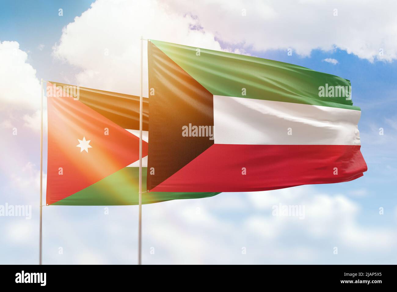 Sunny blue sky and flags of kuwait and jordan Stock Photo - Alamy
