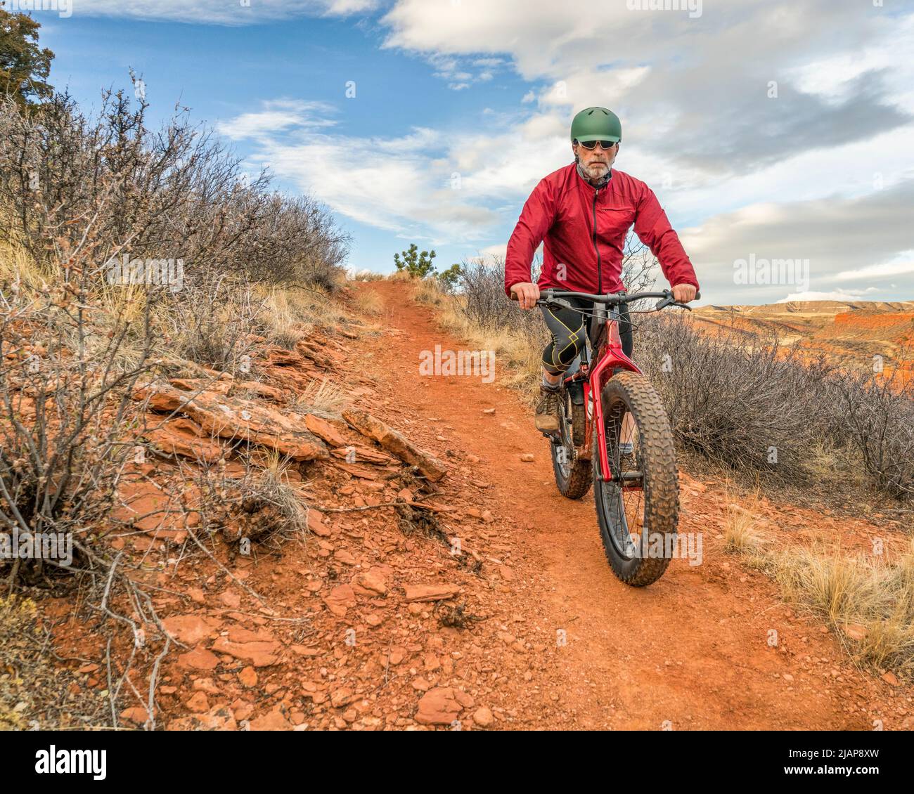 a senior male riding a fat mountain bike on a single track trail in Red ...