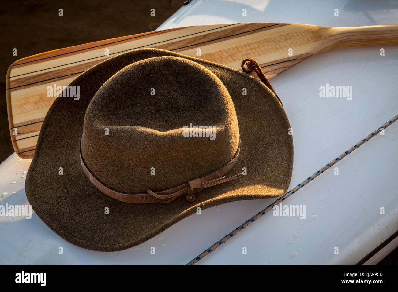 cowboy hat and wooden paddle on a deck of expedition canoe Stock Photo ...