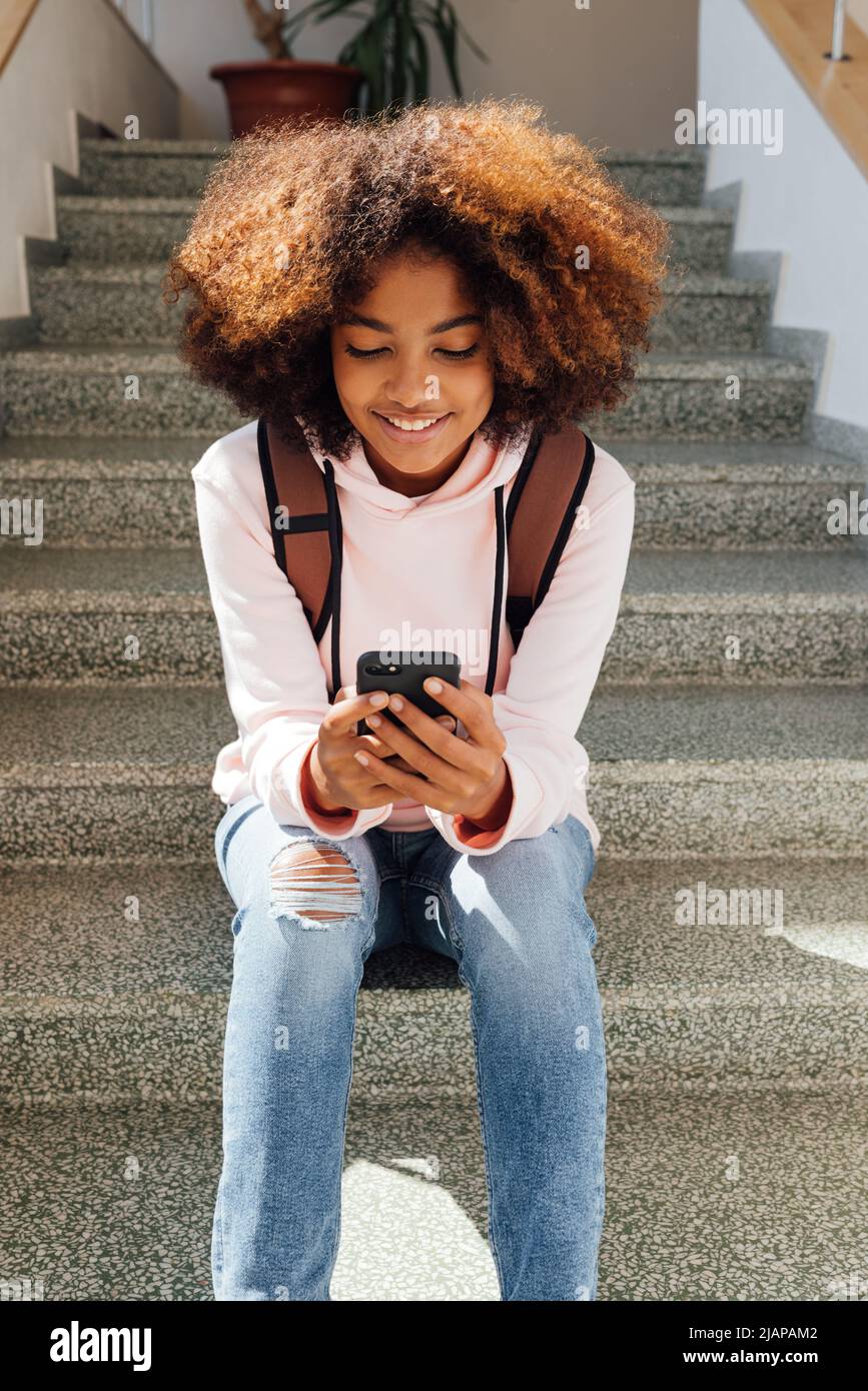 Girl sitting on stairs hi-res stock photography and images - Alamy