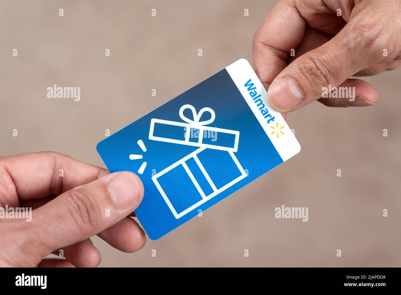 Hand giving out a Walmart gift card isolated Stock Photo - Alamy