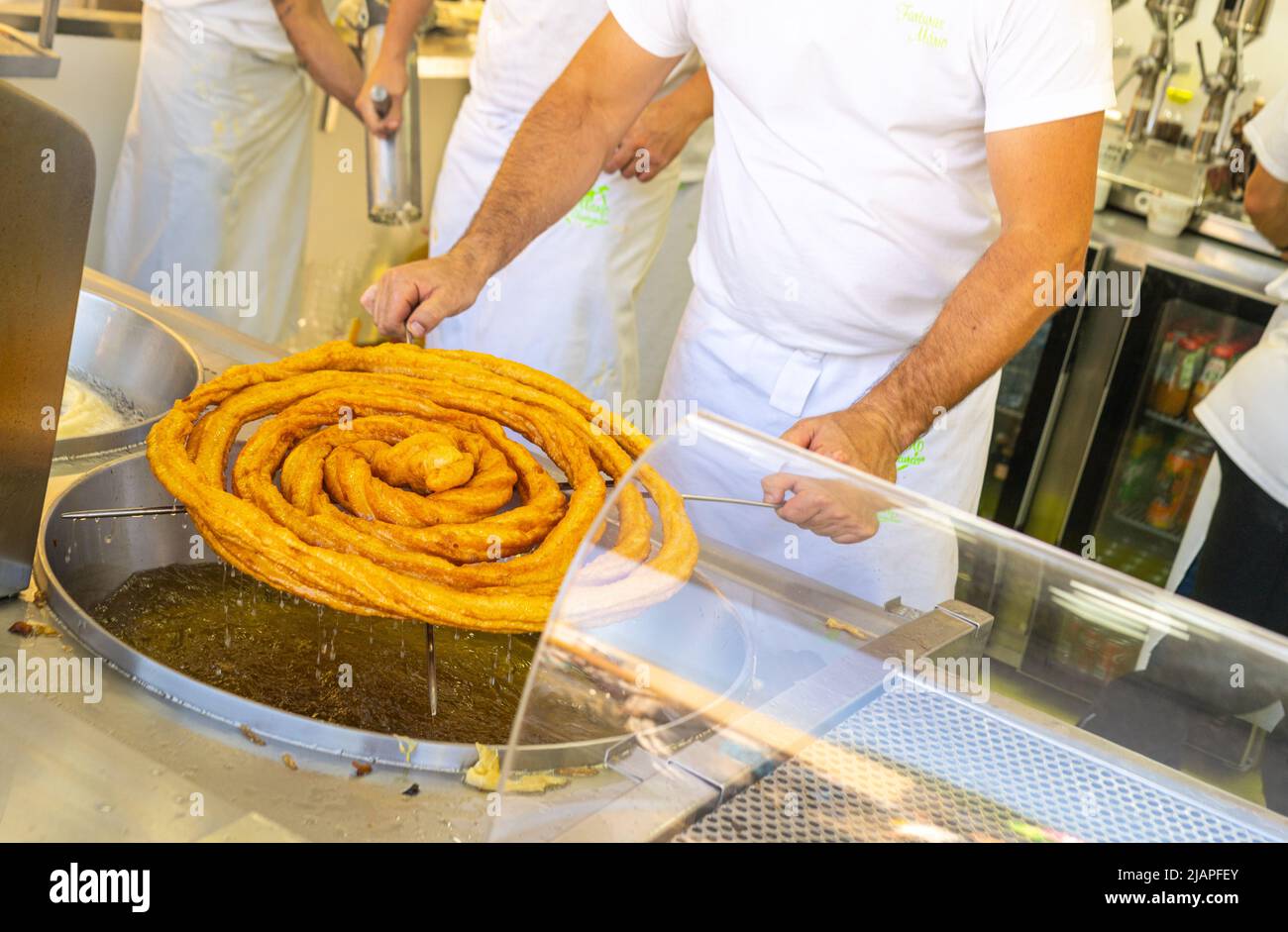 A man making churros in a bar Stock Photo - Alamy