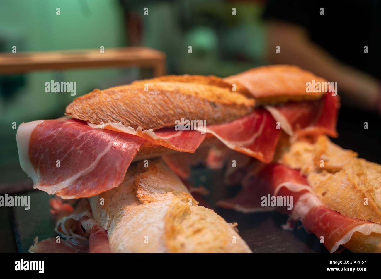 Spanish low cost street food, bocadillo bread sandwich dry-cured ham ...