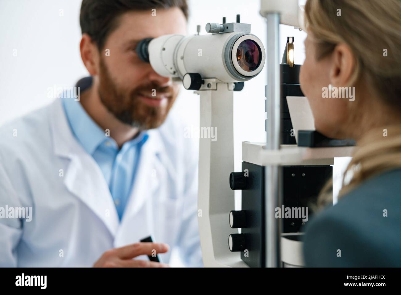 Close-up view of a optometrist checks patient's vision in an optics ...