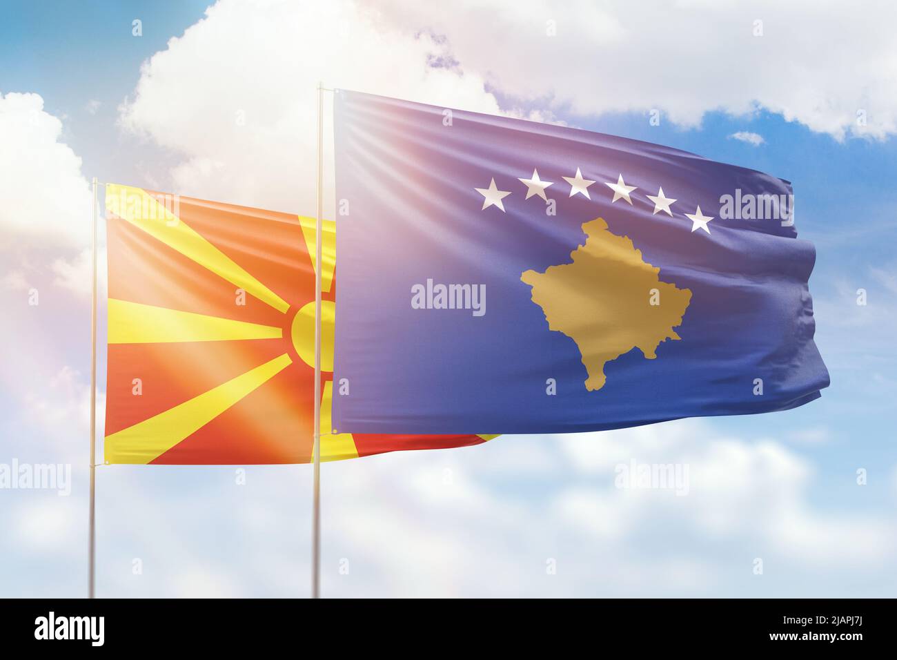 Sunny blue sky and flags of kosovo and north macedonia Stock Photo - Alamy