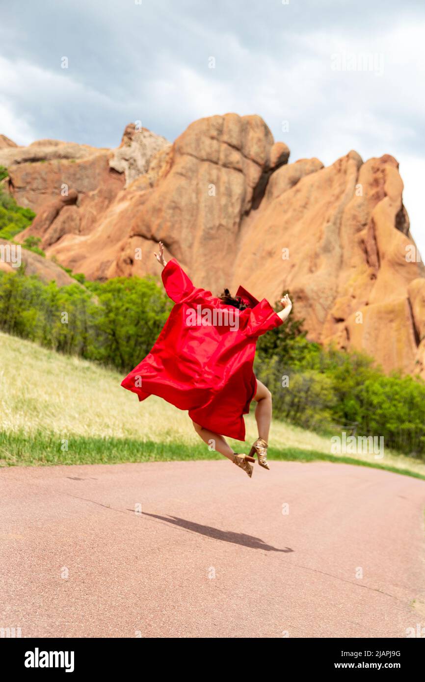 Female High School Student in red graduation cap and gown Stock Photo ...