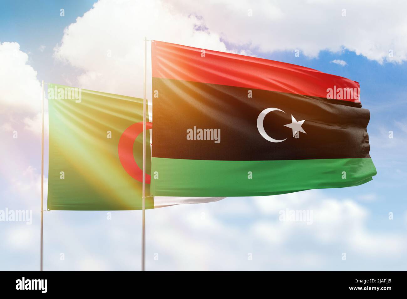 Sunny blue sky and flags of libya and algeria Stock Photo - Alamy