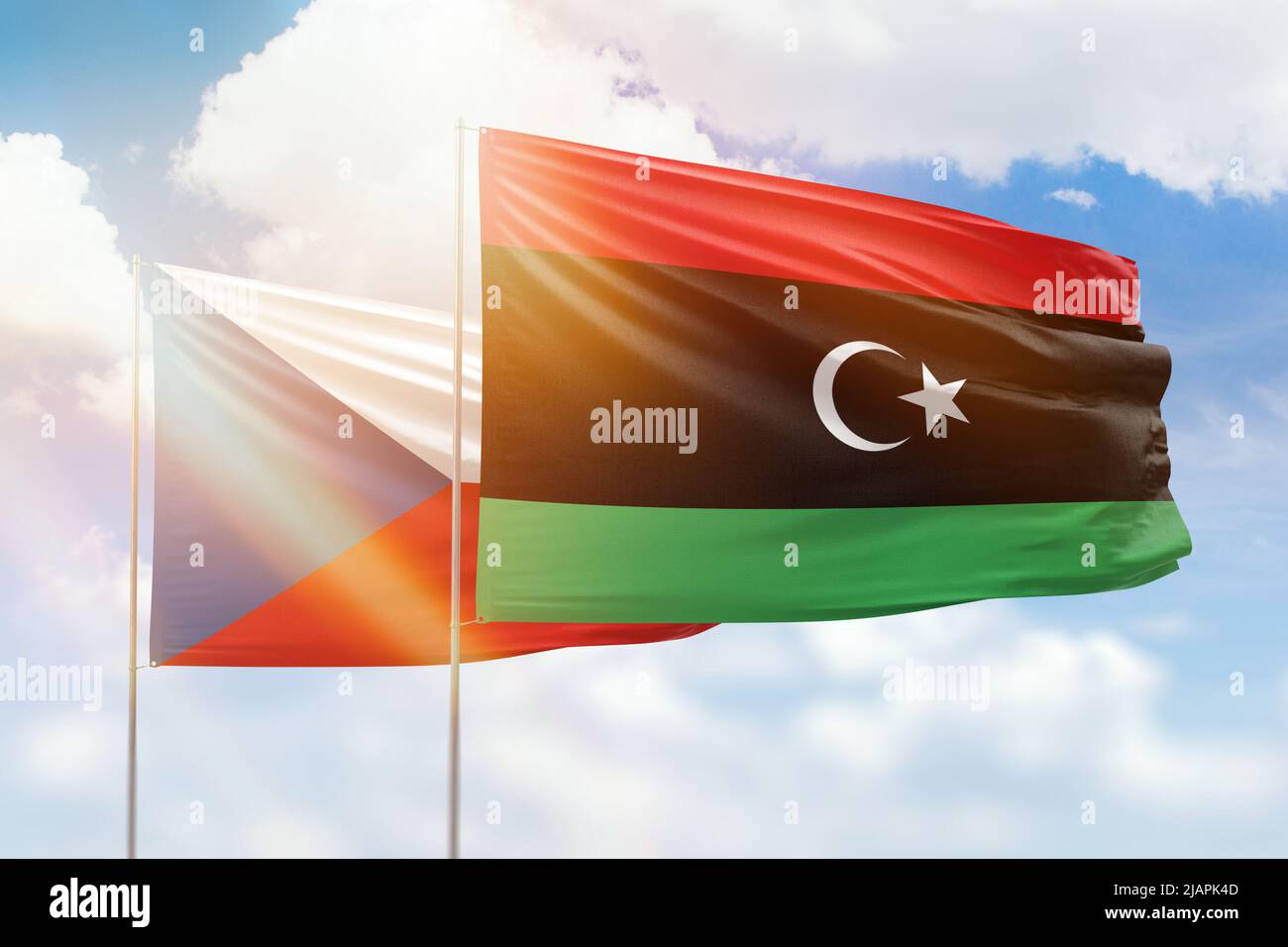 Sunny blue sky and flags of libya and czechia Stock Photo - Alamy